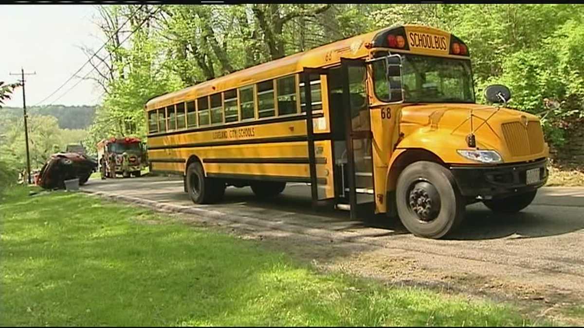 Father, toddler hurt after car clips school bus, flips off road