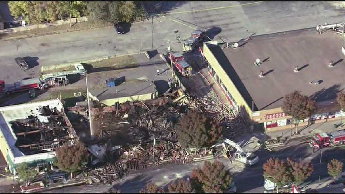 Burned building still smoldering nearly 24 hours later