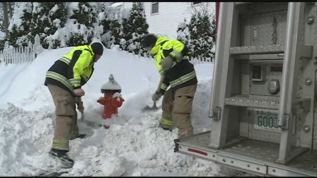 Firefighters work to clear fire hydrants