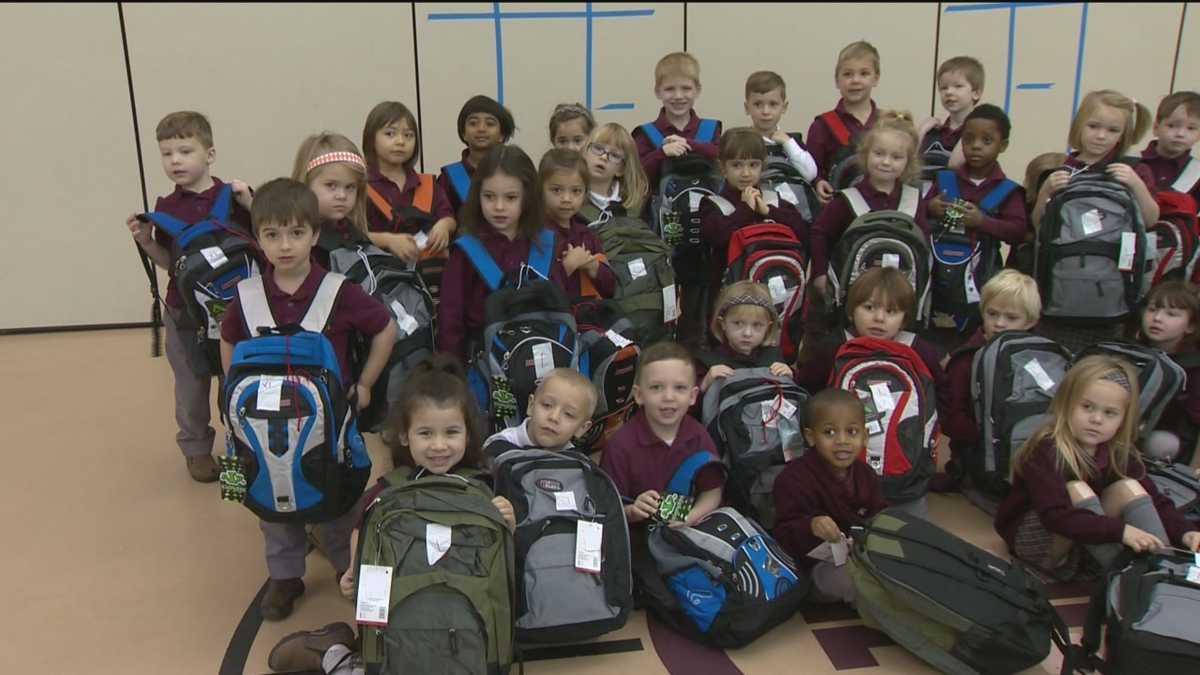 Students fill backpacks for needy