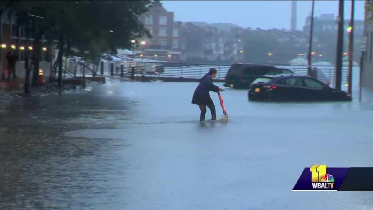 Man drives scooter through flood in Fells Point