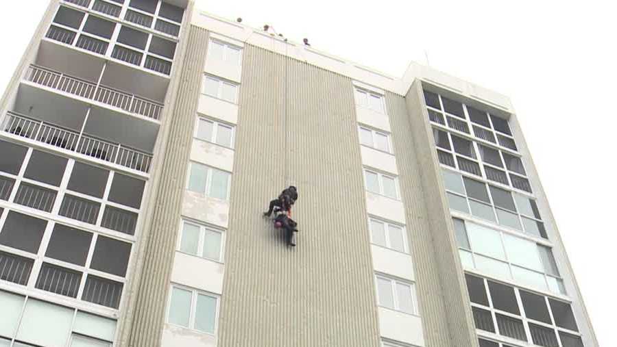 Anchorage firefighters repell down building as a part of rope rescue ...