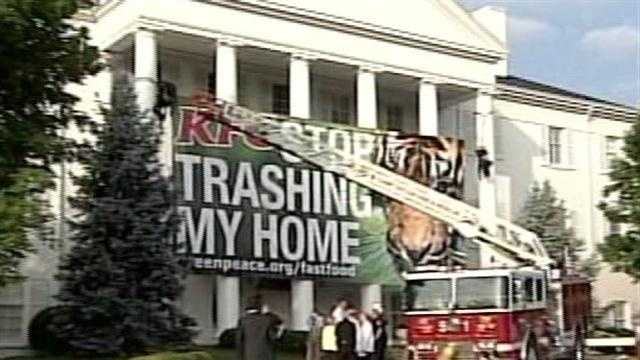 Activists hang protest banner at YUM