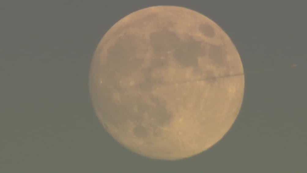 Watch: Jet passes directly in front of full moon