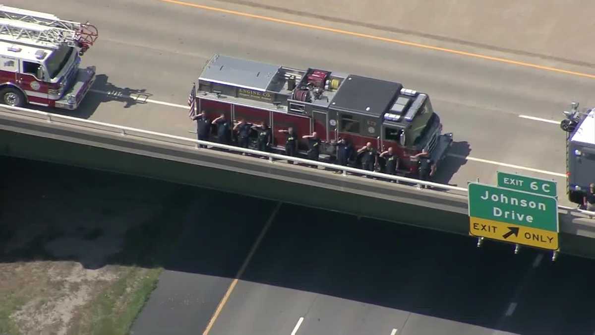 Firefighters, officers salute officer Jonah Oswald during procession