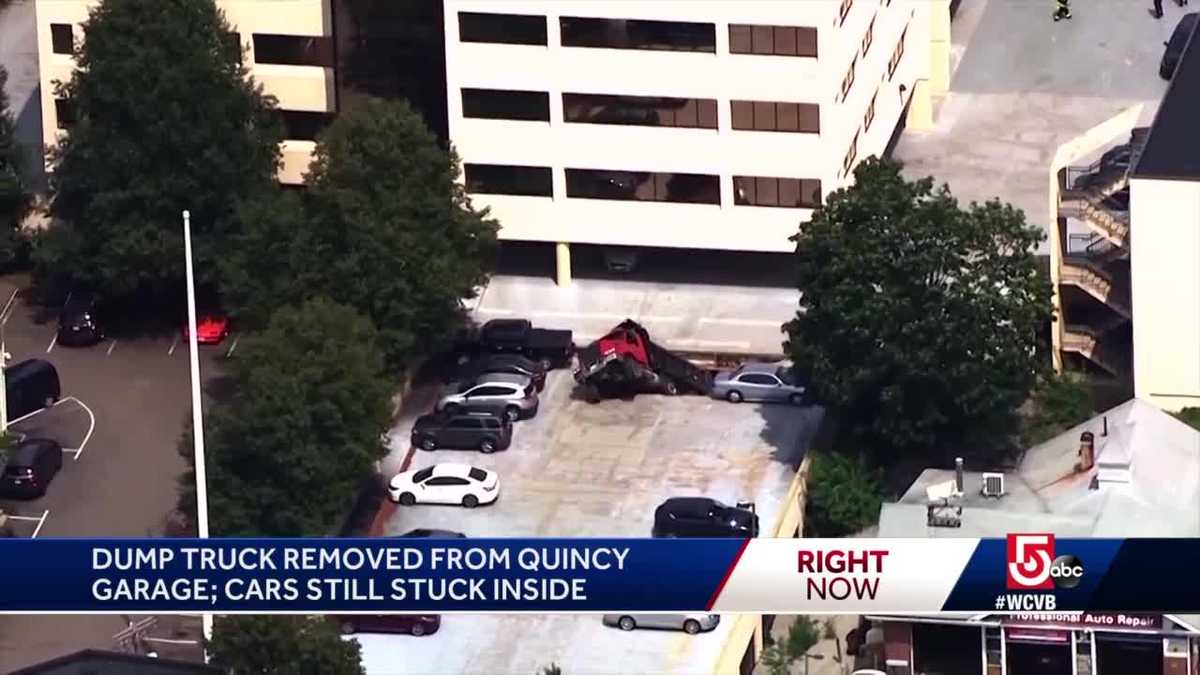 Dozens of vehicles stuck in garage after truck falls through roof
