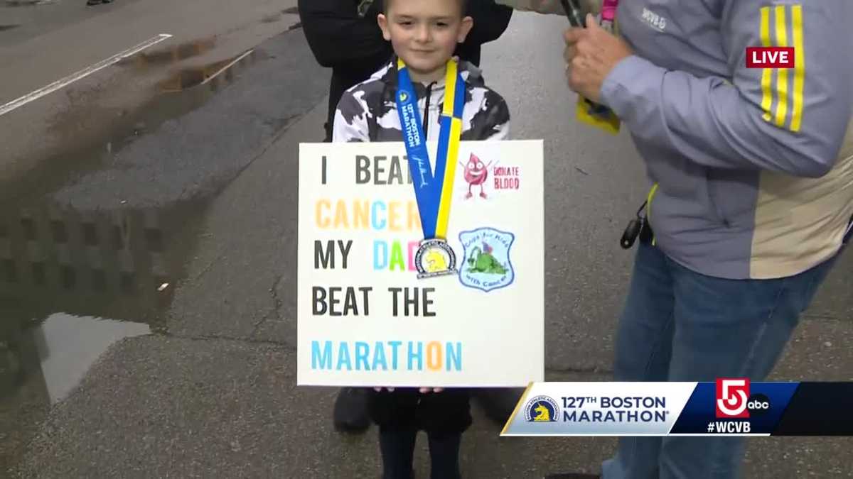 'I Beat Cancer' sign held by son as father finishes Boston Marathon