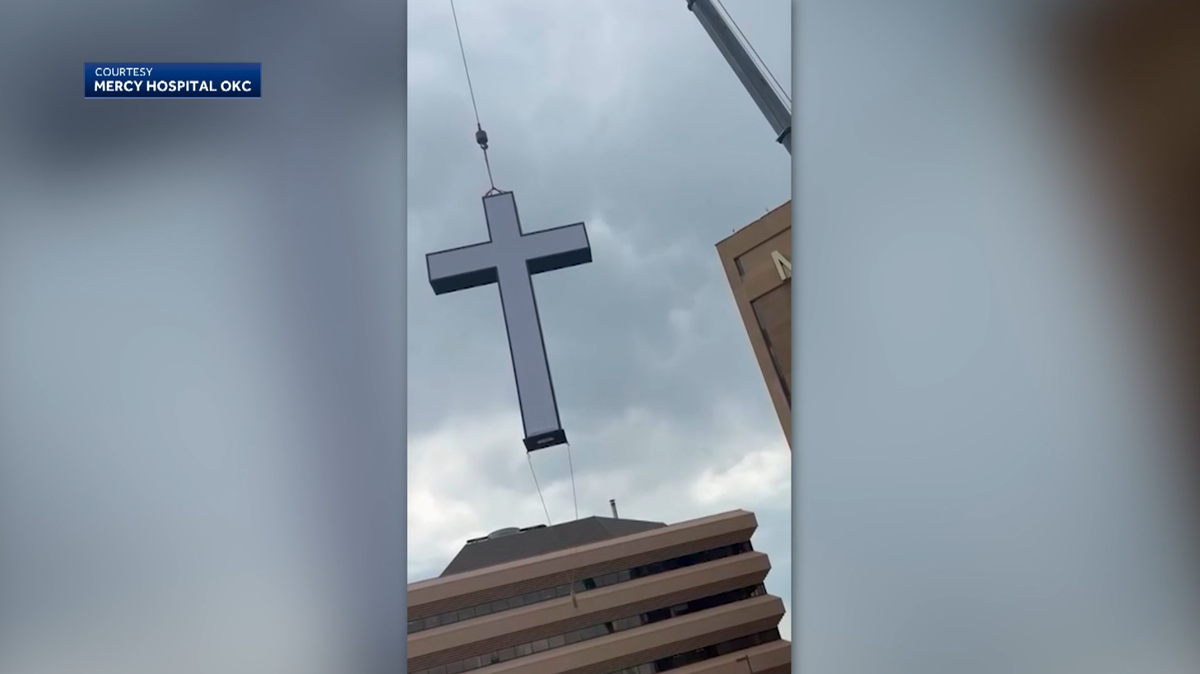 Mercy Hospital OKC cross lifted back onto tower building