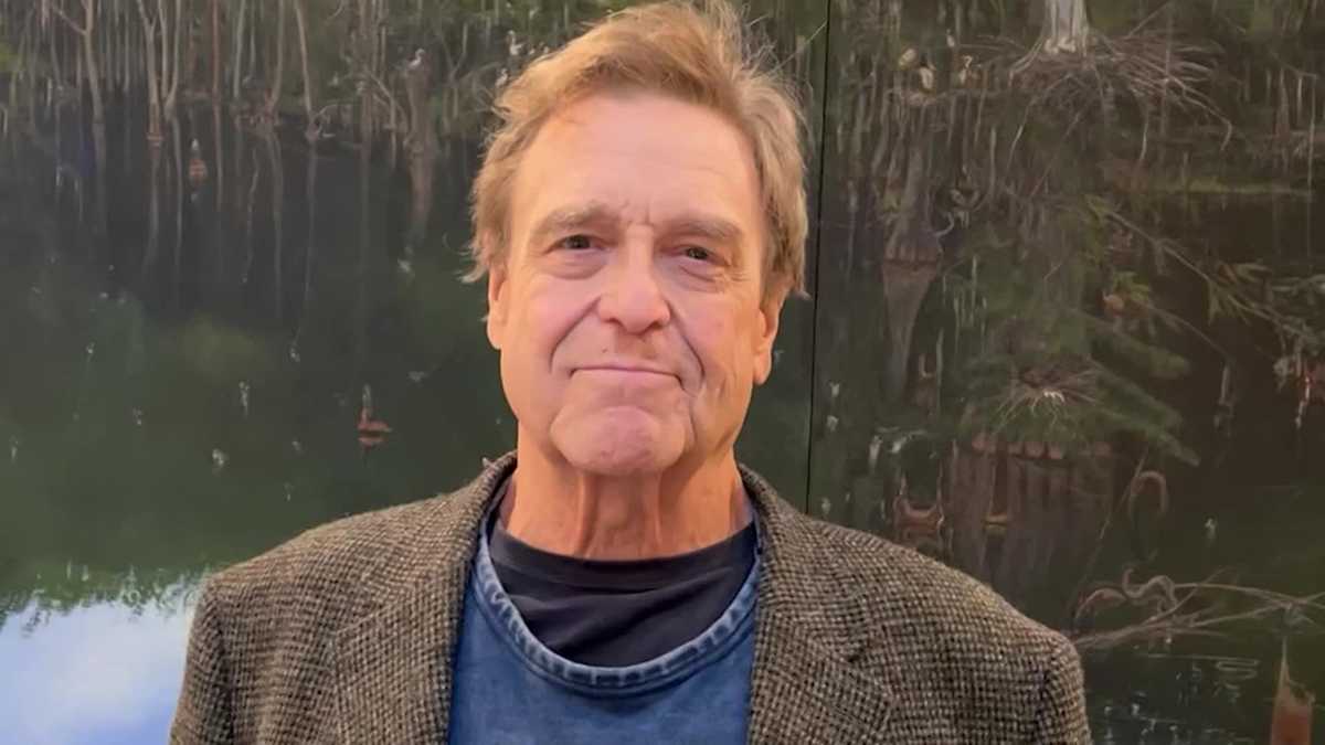 Actor John Goodman congratulates Margaret Orr on her retirement