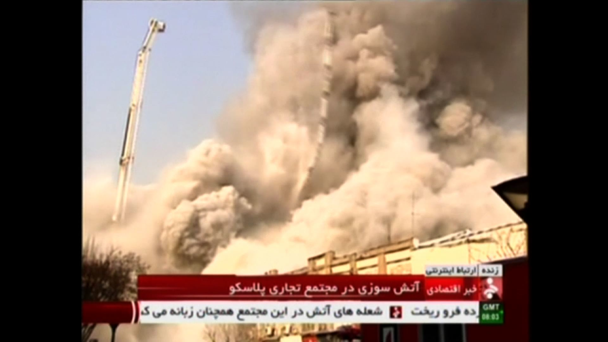 Raw: High-Rise Tower On Fire In Iran Collapses