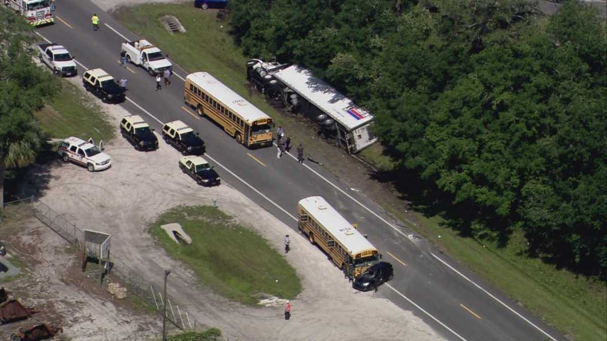 Two adults taken to hospital following crash involving school bus, semi