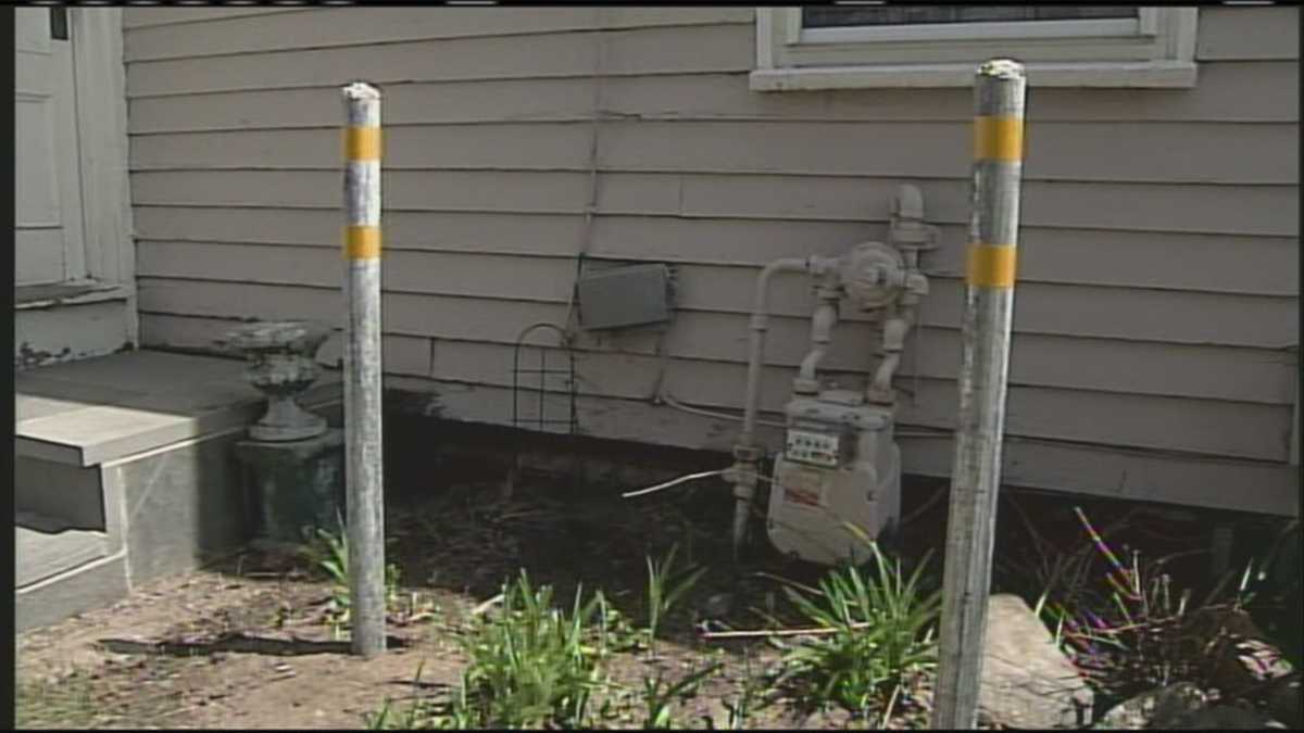 Woman upset by poles placed around gas meter