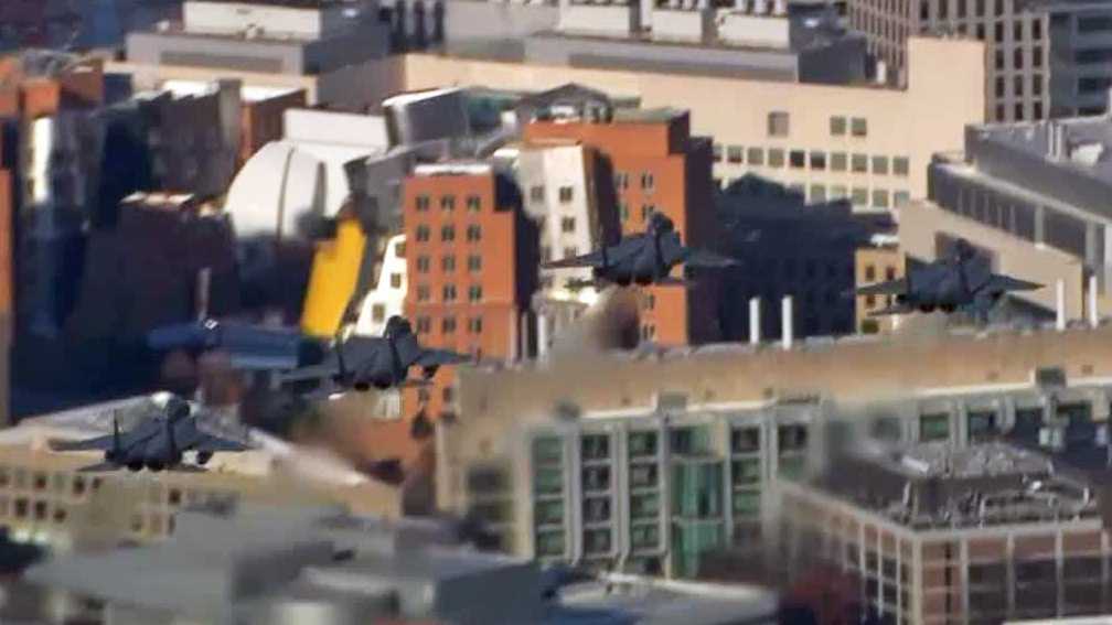 F-15s fly in precise formation over Boston landmarks