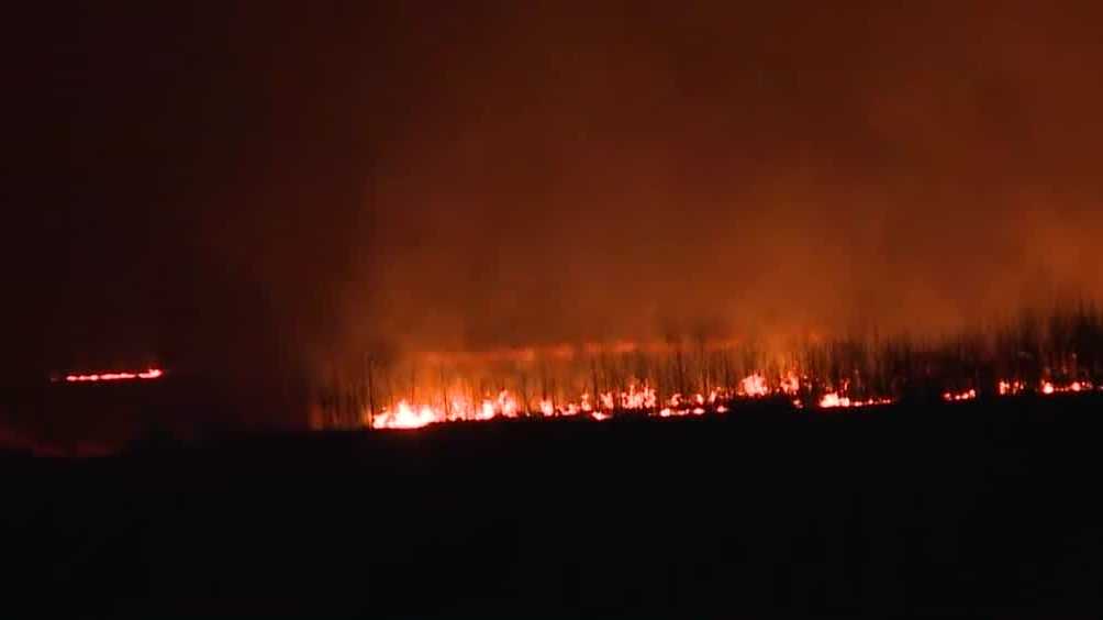 Field fire near Runnells spreads for miles