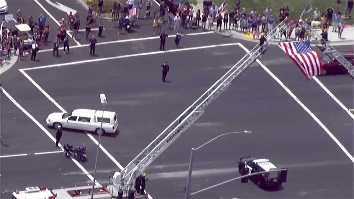 Officer Tara O'Sullivan's procession begins with salutes, flags