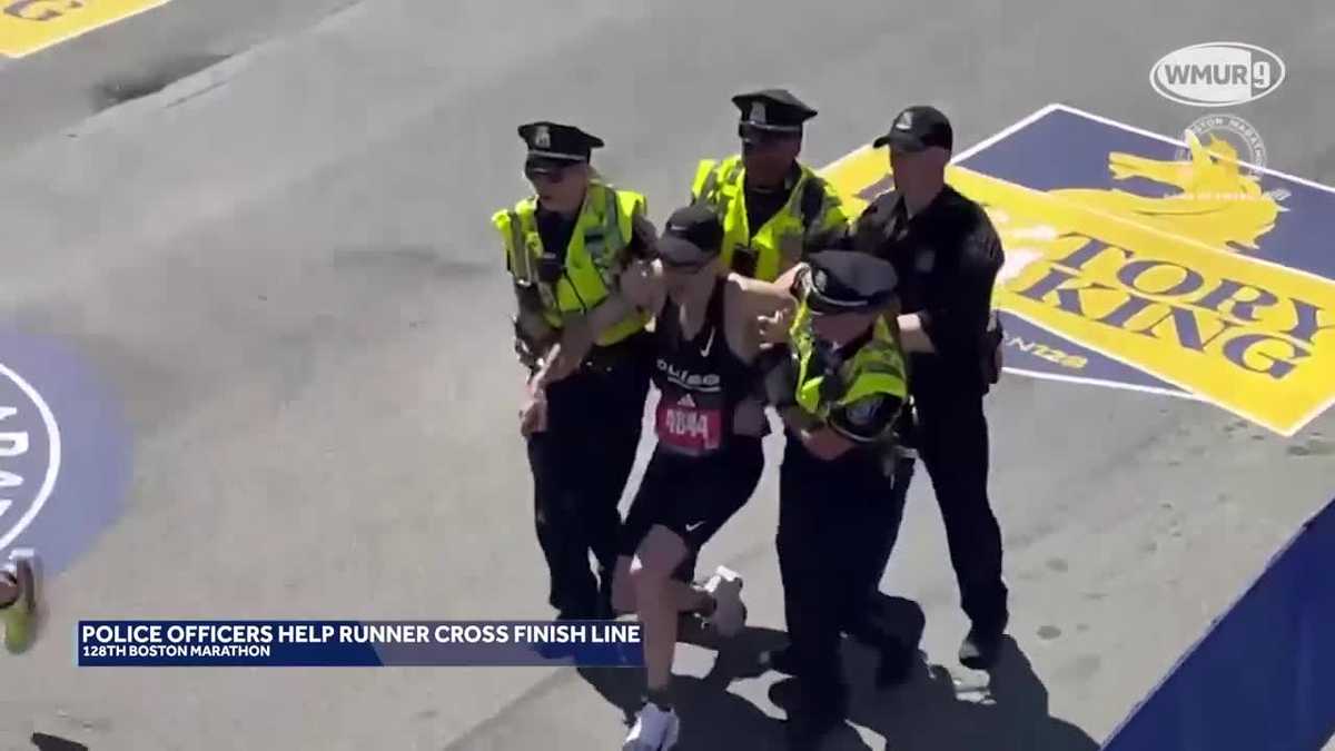 Police officers help runner cross Boston Marathon finish line