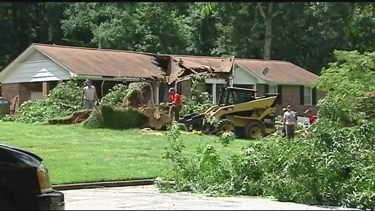 Large tree falls through home