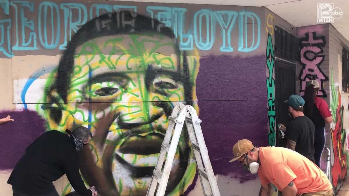 Artists paint George Floyd mural on Milwaukee storefront