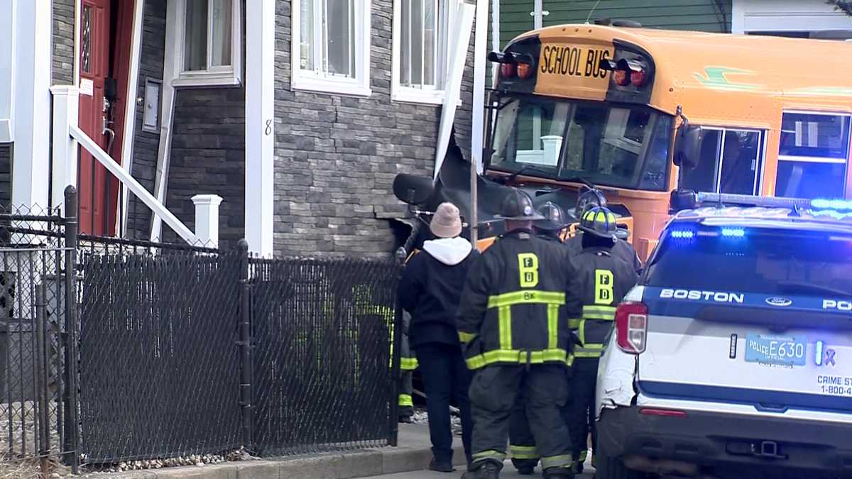 Four people taken to hospital after school bus crashes into Boston home