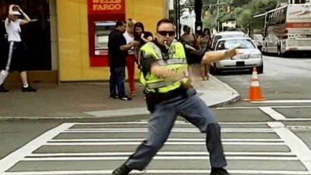 Dancing police officers direct traffic