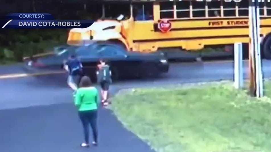 Video shows boy, 7, nearly getting hit by car when crossing road for bus