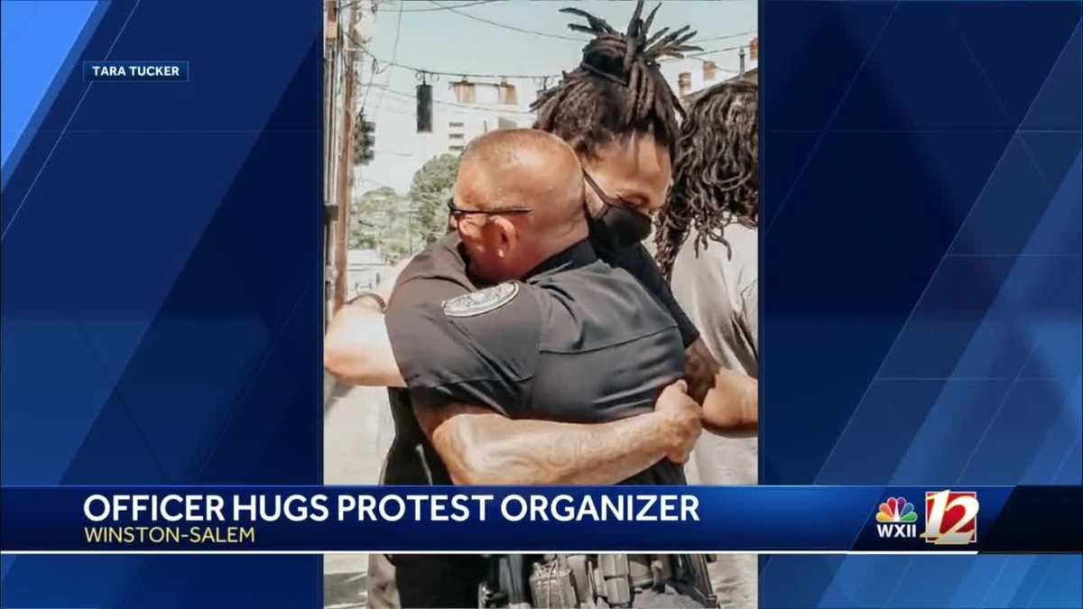 Winston-Salem police officer hugs protest organizer outside barber shop