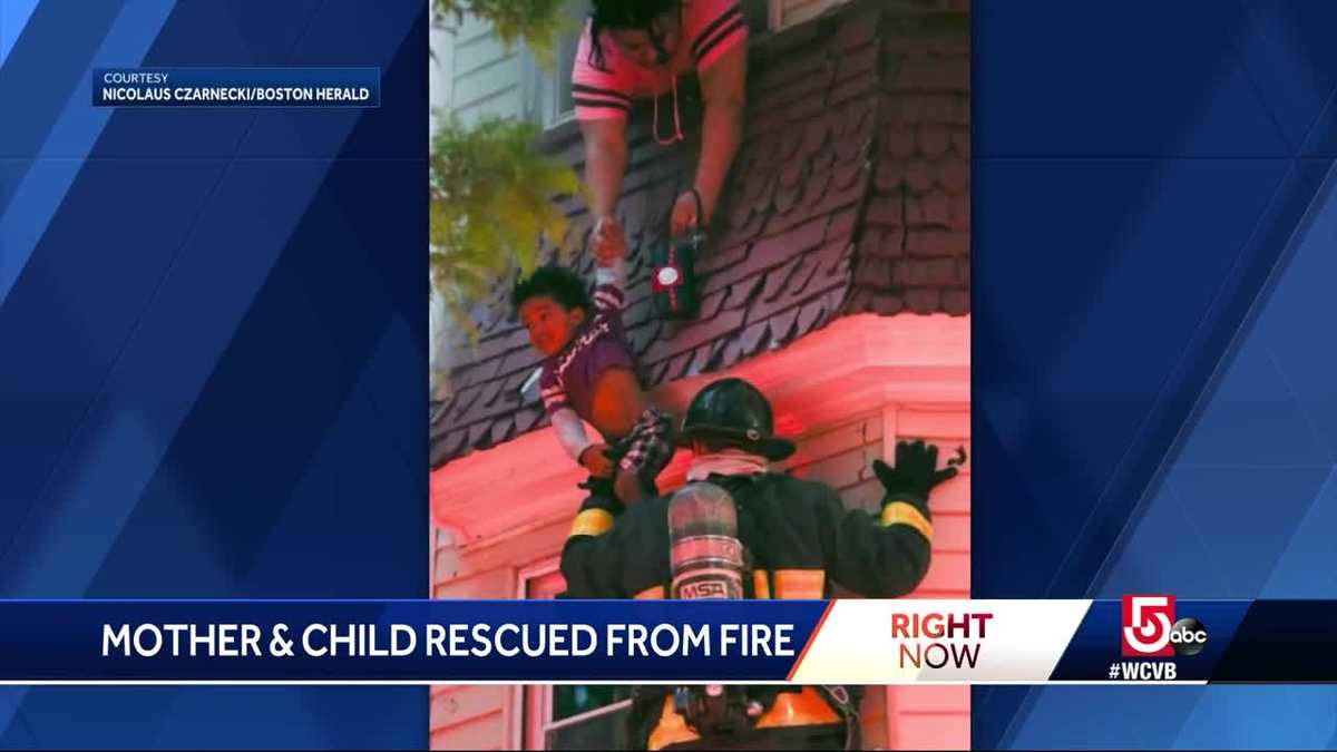 Dramatic photos show firefighters rescuing child from fire