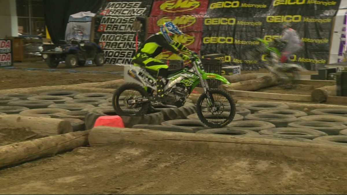 Motorcycles race through obstacle course at Endurocross