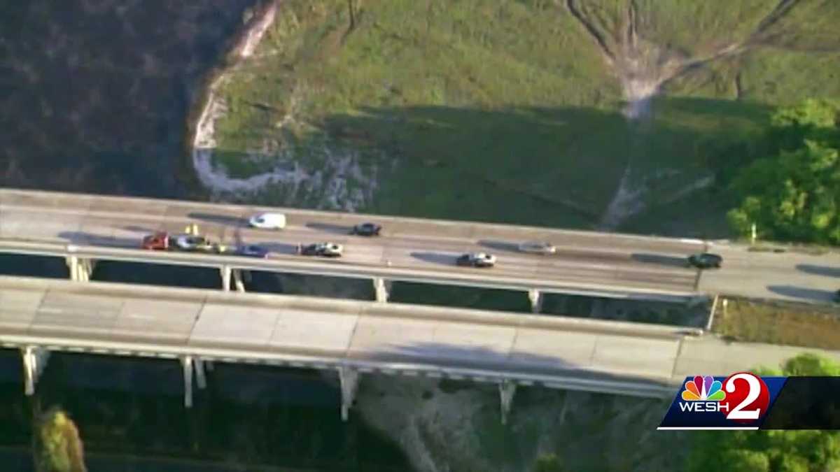 Firefighter, driver fall from bridge after fiery crash