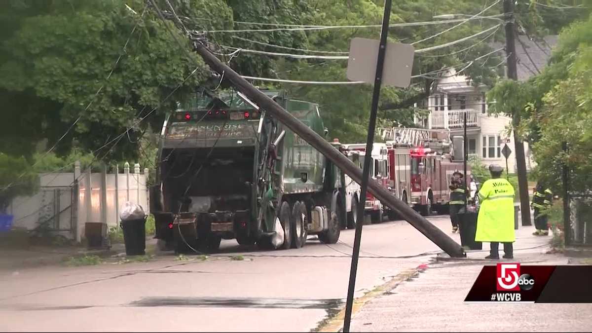 Utility pole, powerlines crash onto garbage truck