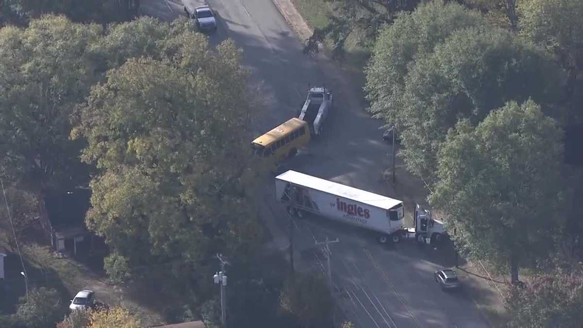 Tractor-trailer, special education school bus with students on board ...