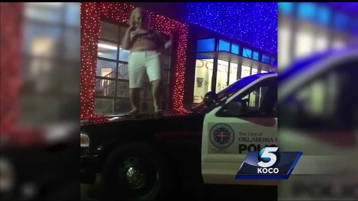 Woman caught on camera jumping on top of metro police car