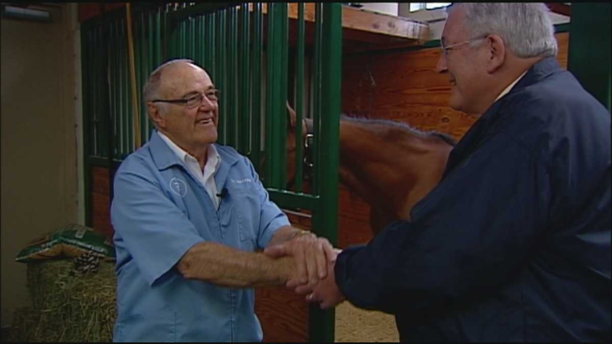 Larry Moore salutes veterinarian Bud Hertzog
