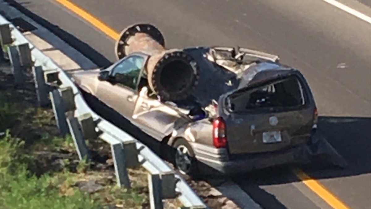 Driver walks away after huge pipe crashes onto van