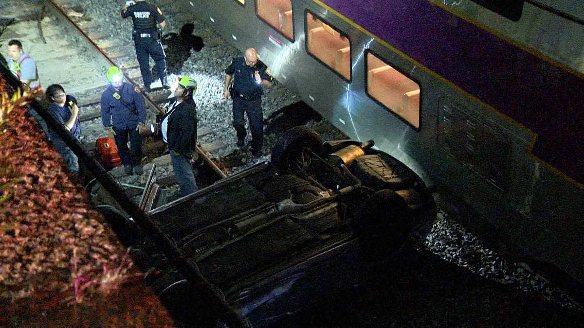 Boston crash sends car off 20-foot ledge, onto train tracks