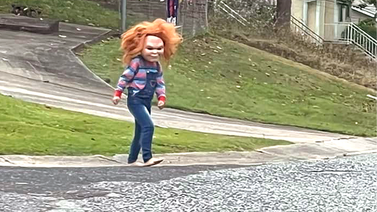 Little boy dressed as Chucky roaming his neighborhood
