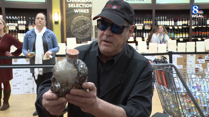 Actor Dan Aykroyd signs bottles of his vodka in Lancaster