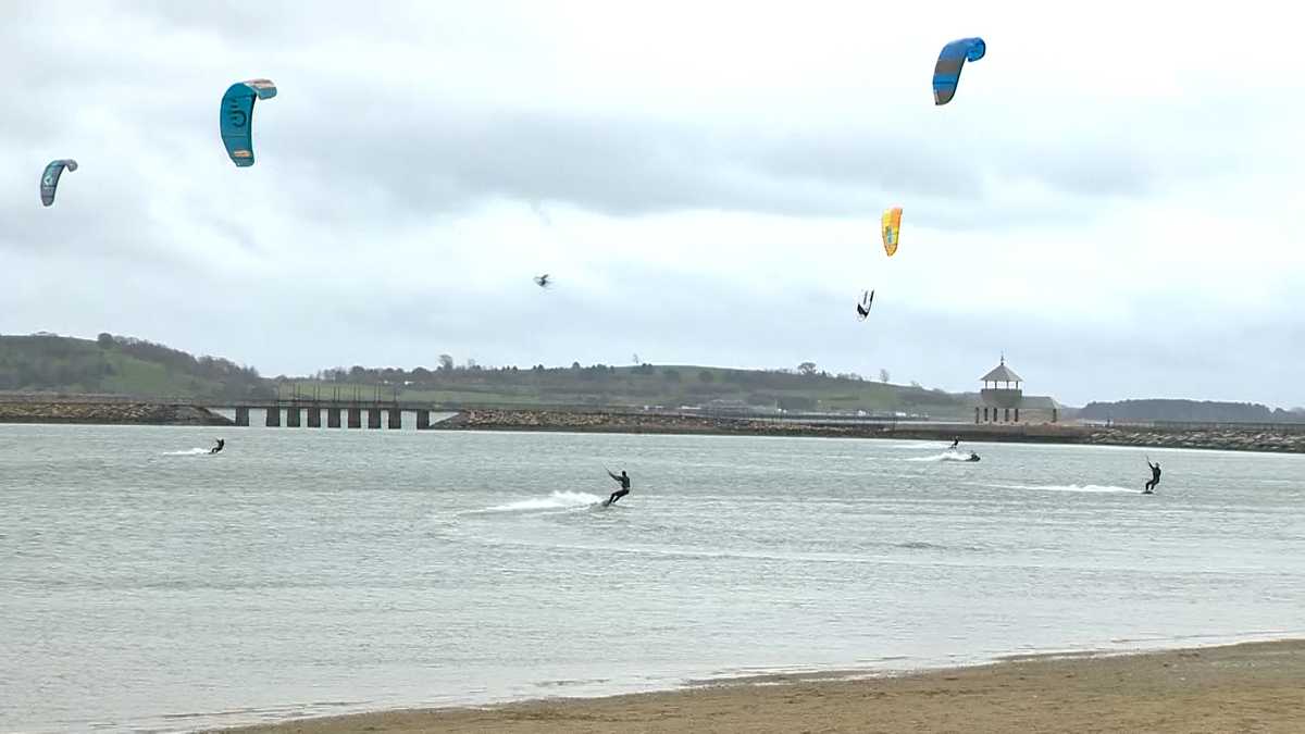 Surfers hit the water in Boston as Nicole remnants pass through