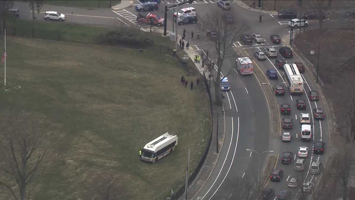 MBTA bus crashes through cemetery fence after colliding with car