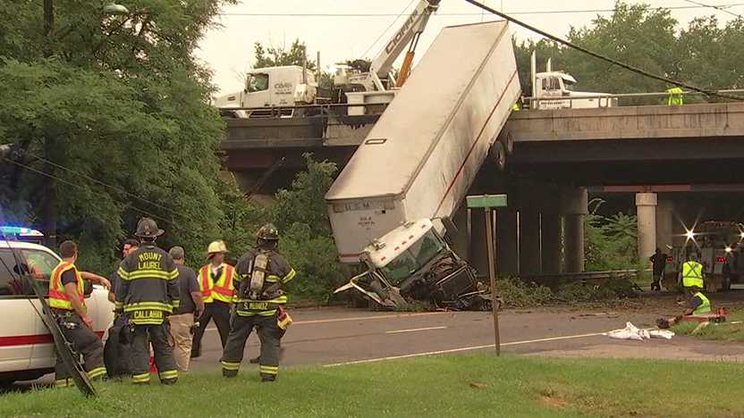 USPS truck tumbles off New Jersey overpass