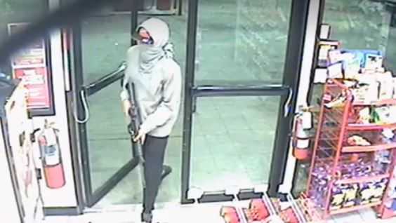 Police Man Caught On Camera Robbing Store With Assault Rifle