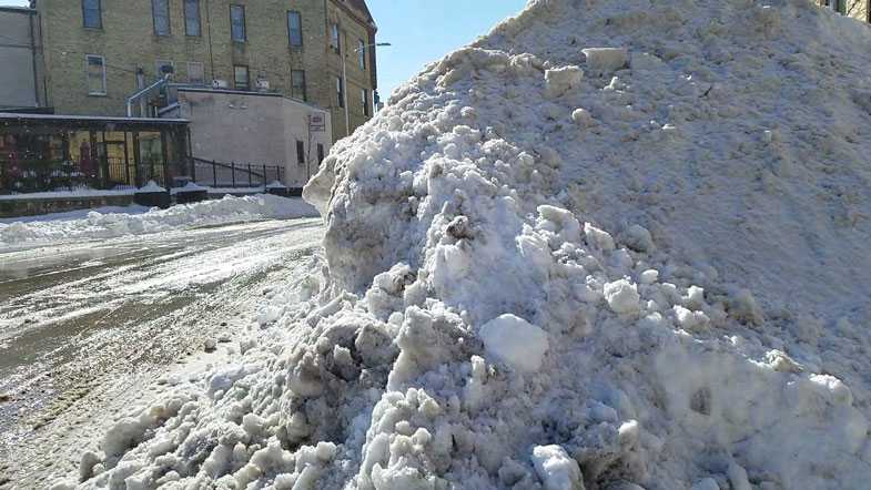 Snowbanks at street corners make for treacherous driving conditions