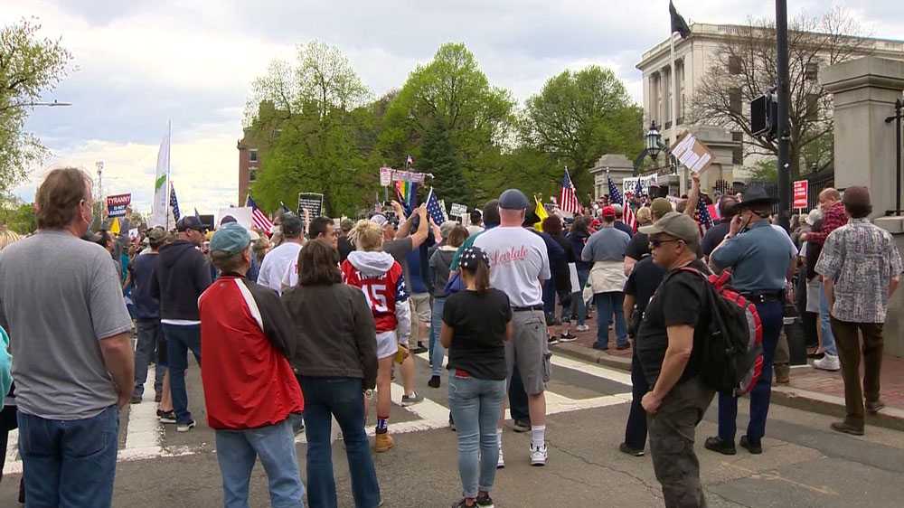 Hundreds of people rally outside State House, urge Baker to reopen