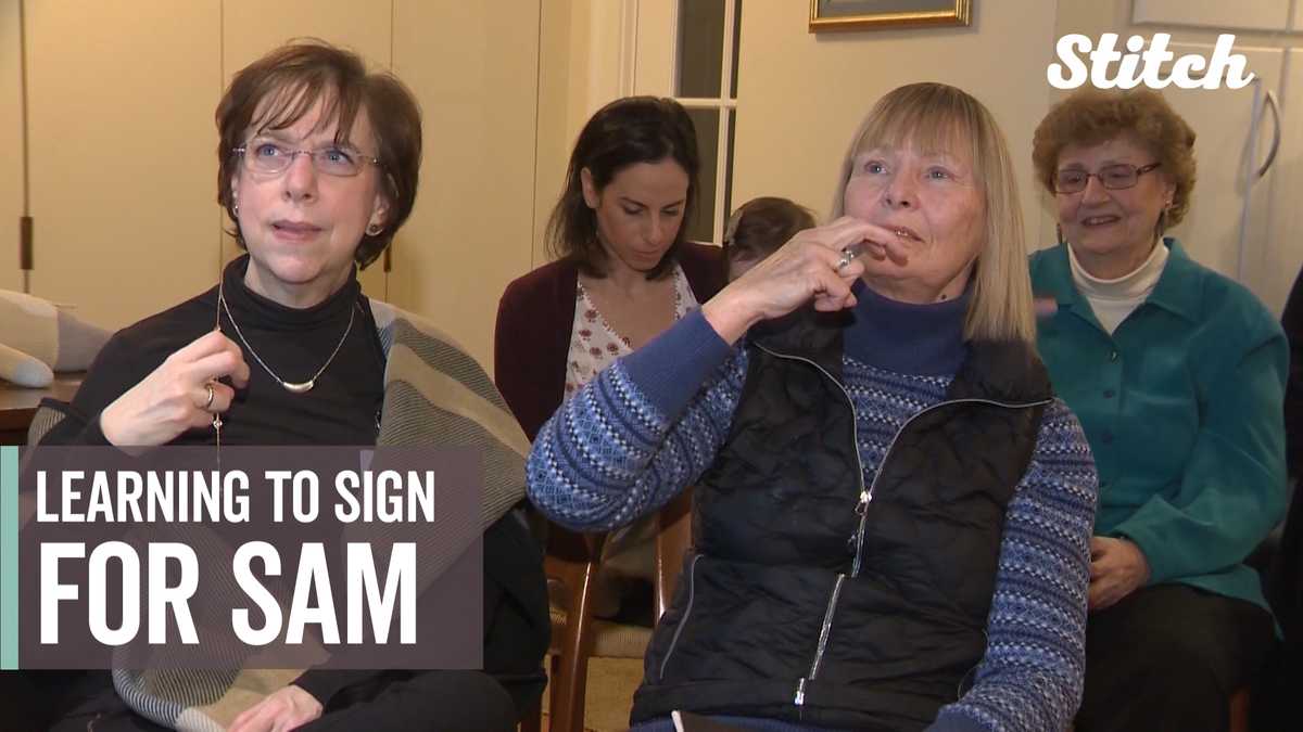 Community members learn sign language in support of infant neighbor