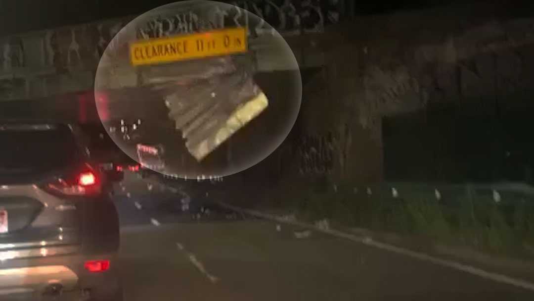 'Storrowed' moving truck left crinkled roof behind on low bridge