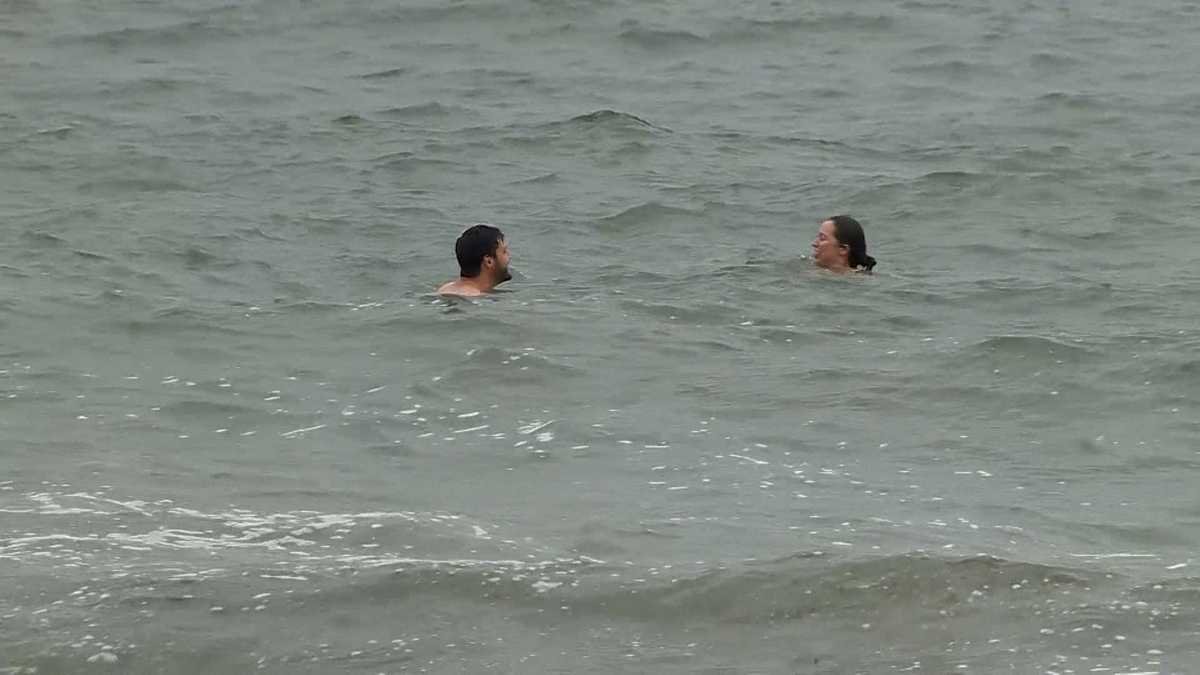 Swimmers take dip in ocean off Cape Cod before nor'easter intensifies