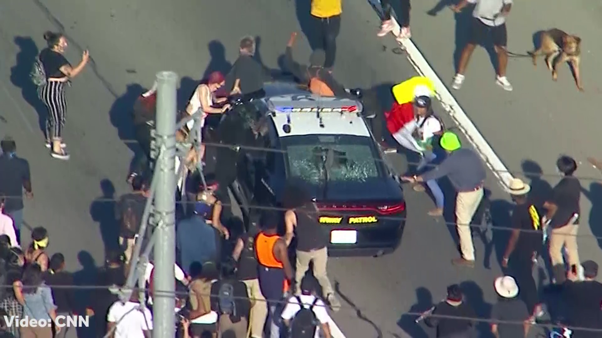 Protesters stop LA freeway traffic, smash patrol car windows