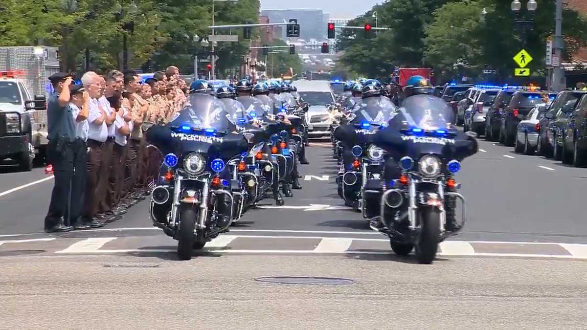 Somber Procession Brings Fallen Officer To Funeral Home